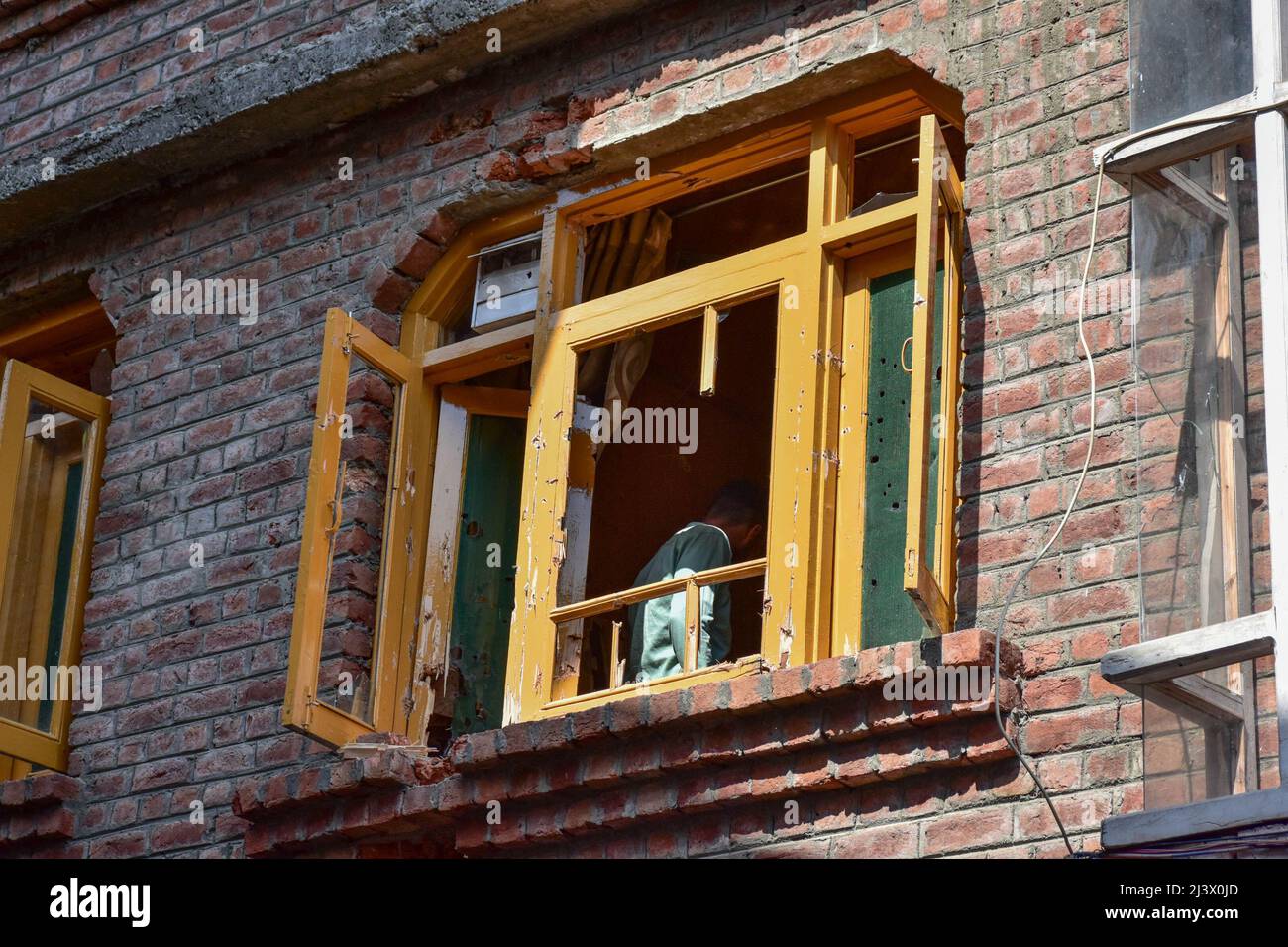 A resident inspects the damaged residential house where the militants ...
