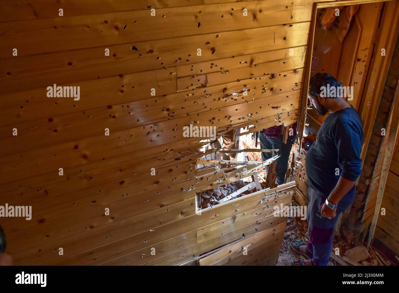 A resident inspects the damaged residential house where the militants ...