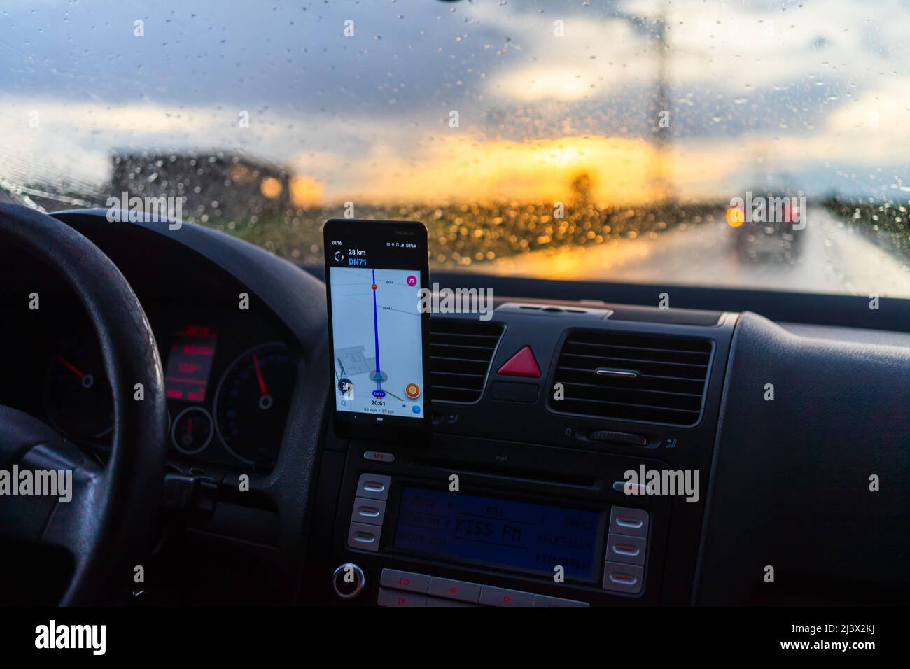 Using waze maps application on smartphone on car dashboard, Driver ...