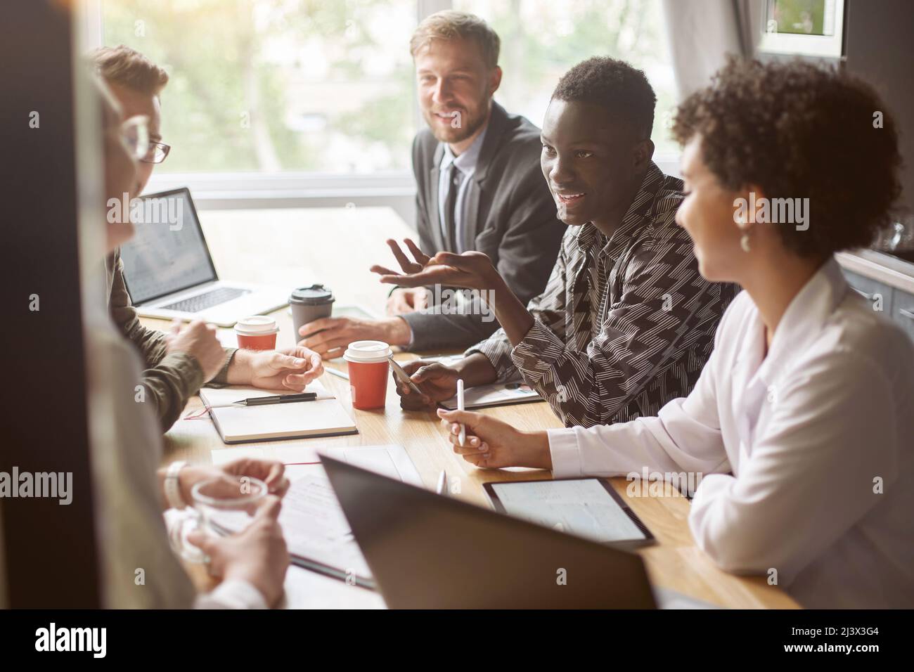young entrepreneurs discussing a joint project in the office of the ...