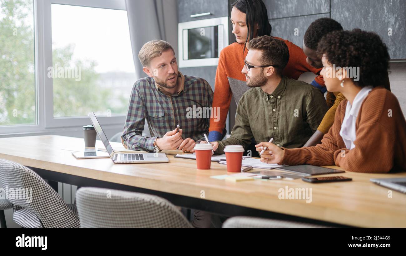 project manager is explaining something to young employees Stock Photo ...