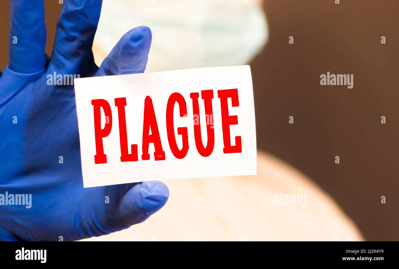 Doctor writing word plague with hands, Medical concept Stock Photo - Alamy