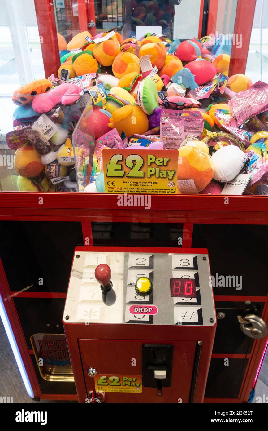 A claw or crane game full of enticing colourful stuffed toys Stock ...
