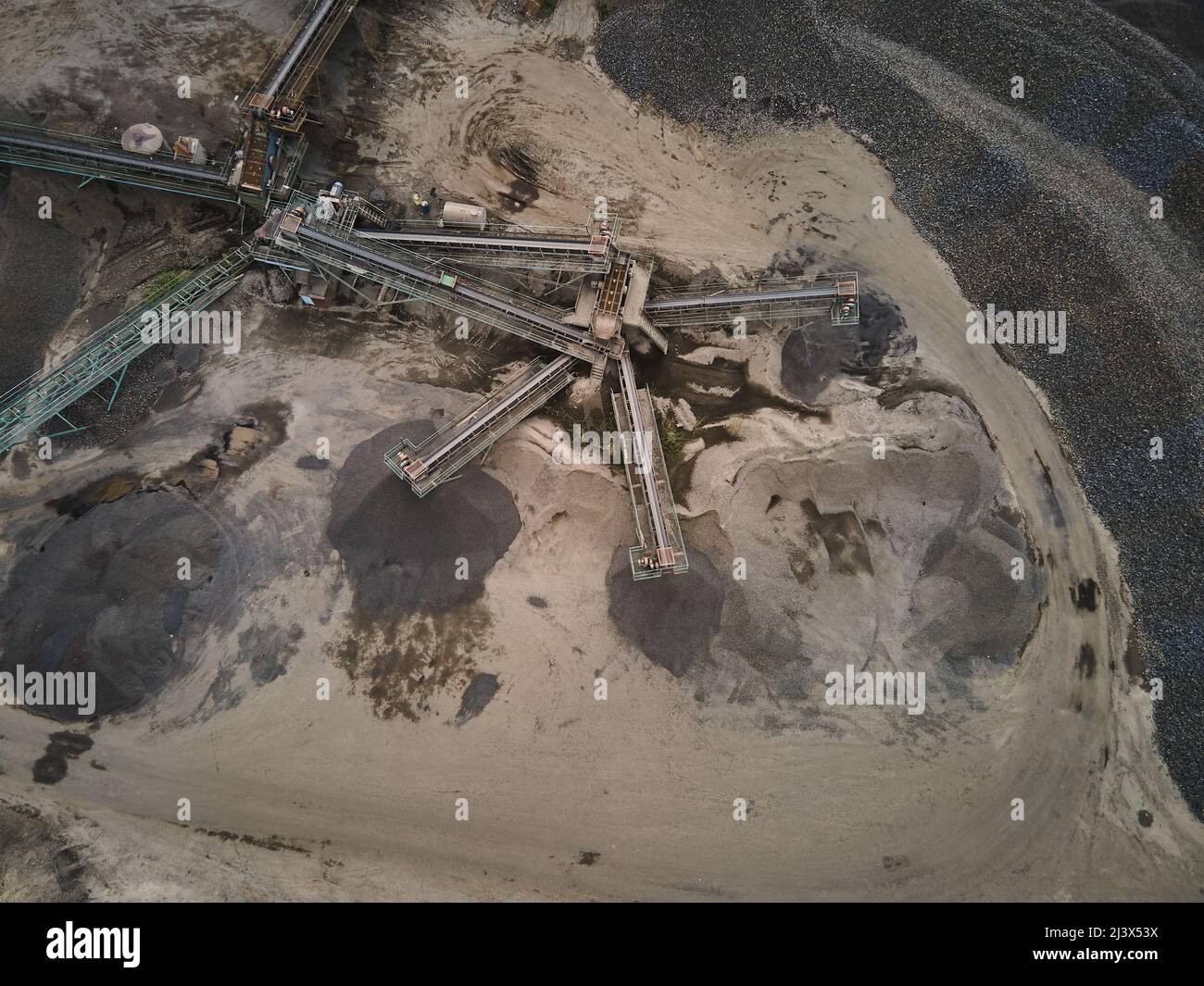 Aerial view basalt quarry of open pit mine machines with sifters and ...