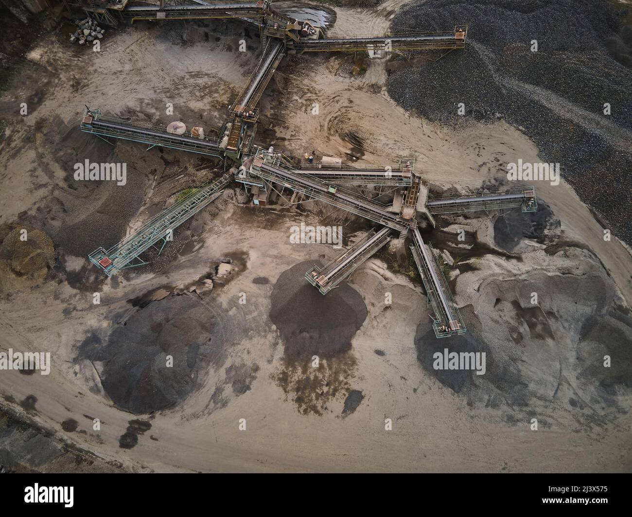 Aerial view basalt quarry of open pit mine machines with sifters and ...