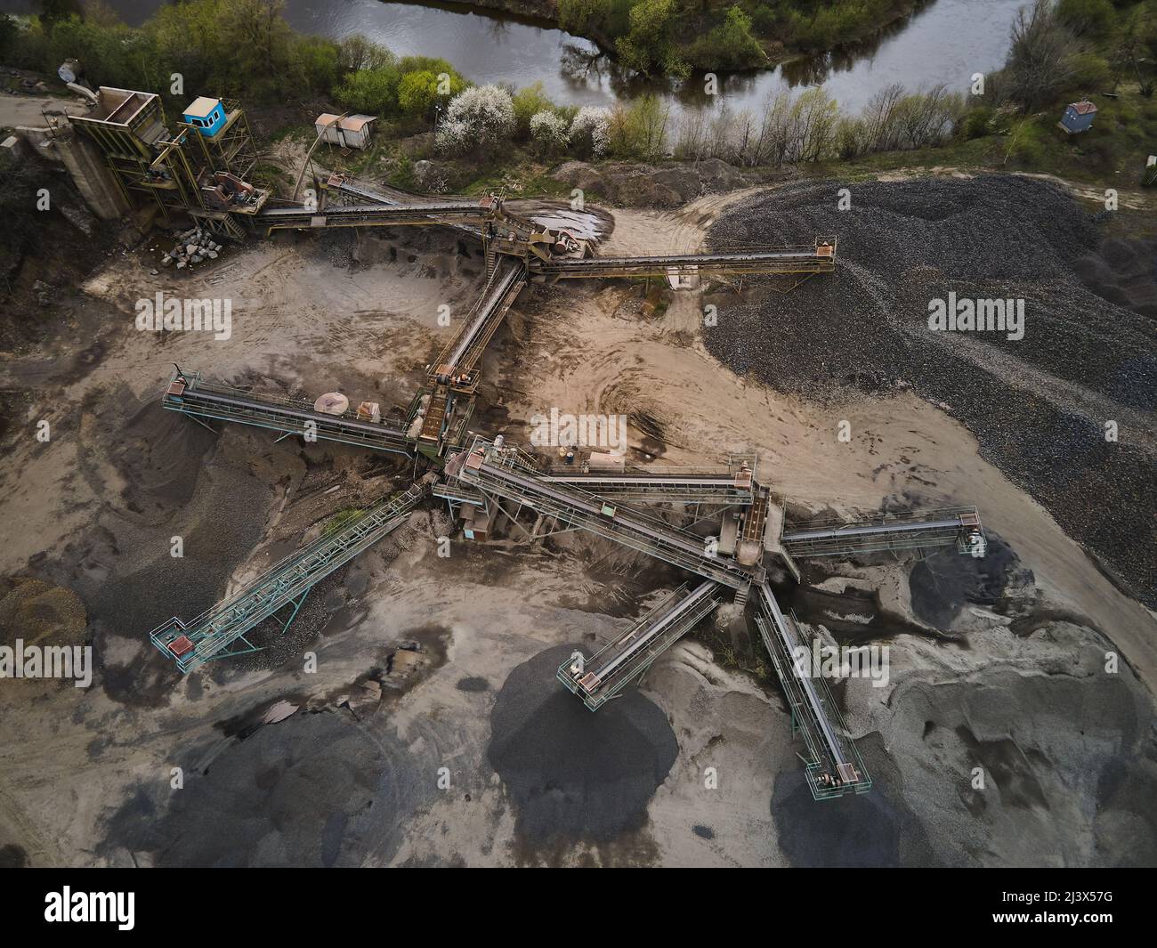 Aerial view basalt quarry of open pit mine machines with sifters and ...