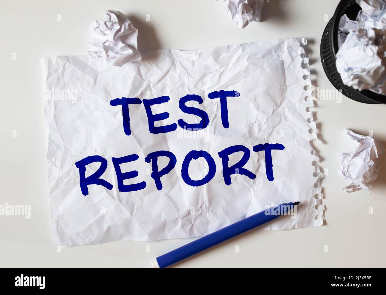 Test Report inscription on crumpled paper. All on a wooden background ...