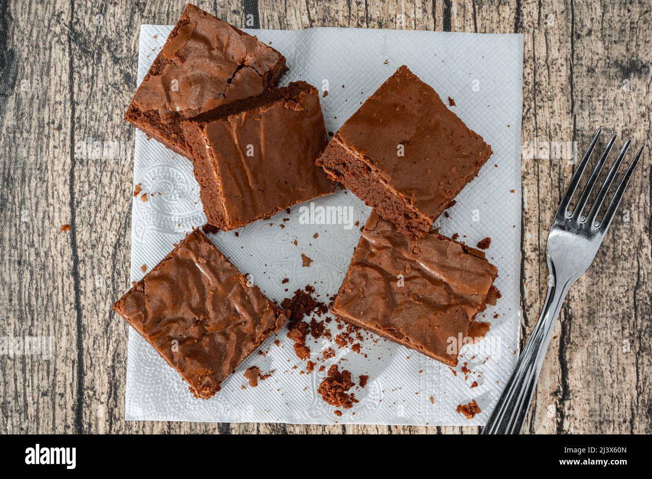 Homemade chocolate brownie squares on a table. Top view Stock Photo - Alamy