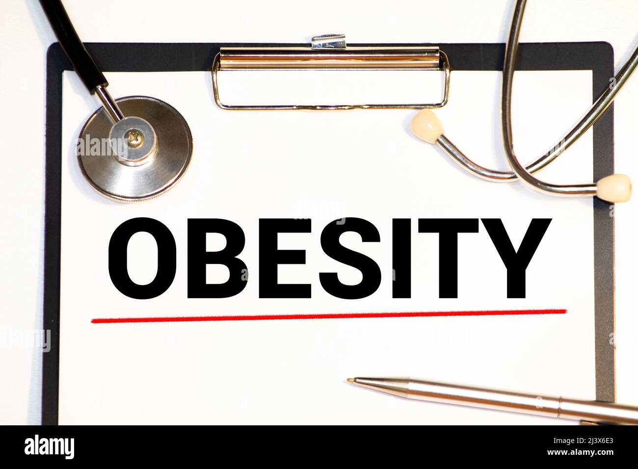 Obesity Word on a white sheet of paper, medical concept, stethoscope ...
