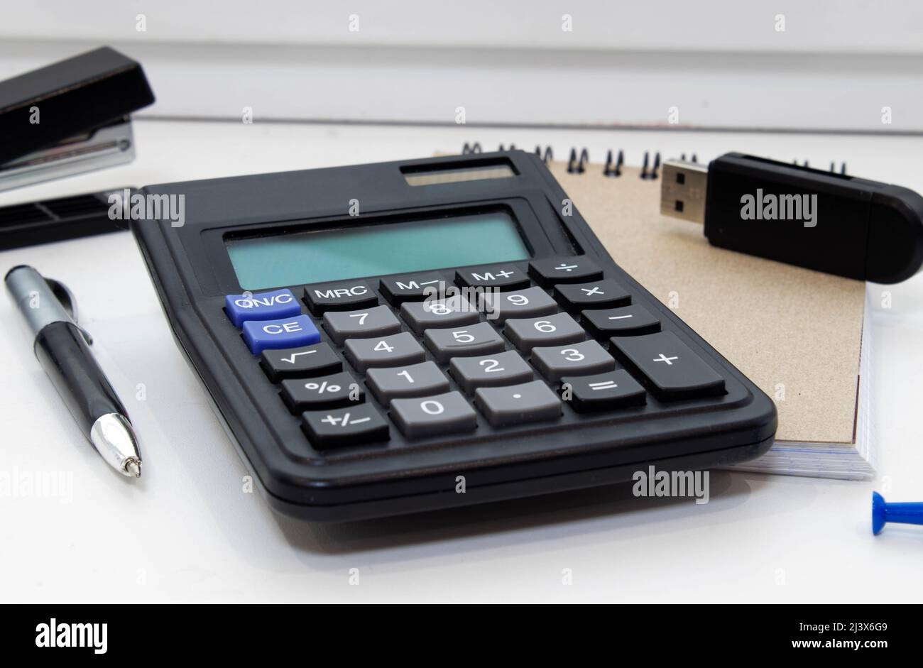 close up calculator with pen on white paper Stock Photo - Alamy