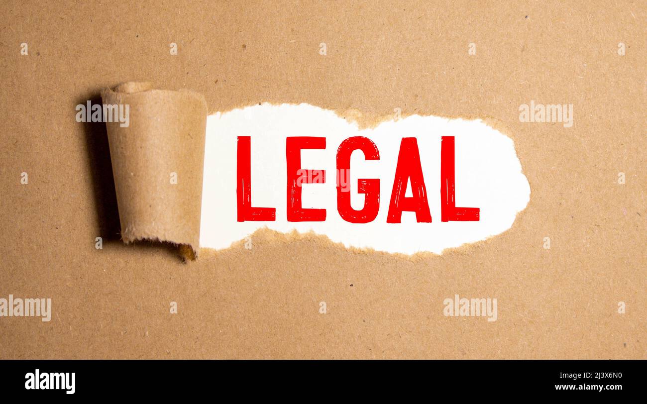 legal. text on white paper on torn kraft cardboard background Stock ...