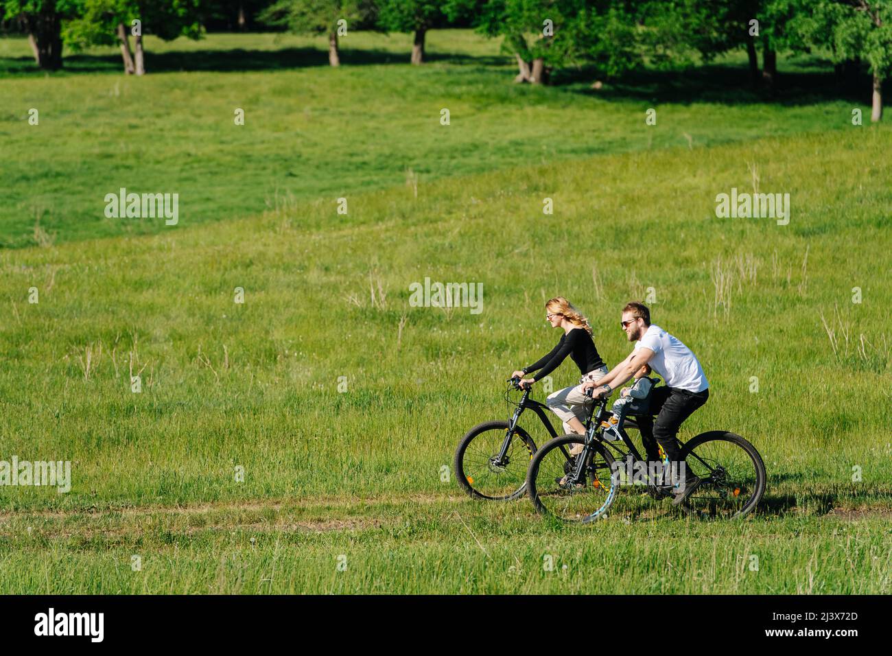 A couple with their child from behind and a hi-res stock photography ...