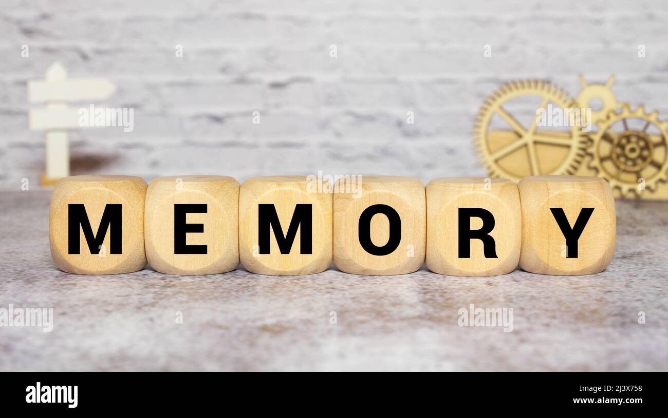 gray word memory from small wooden letters on a blue table Stock Photo ...