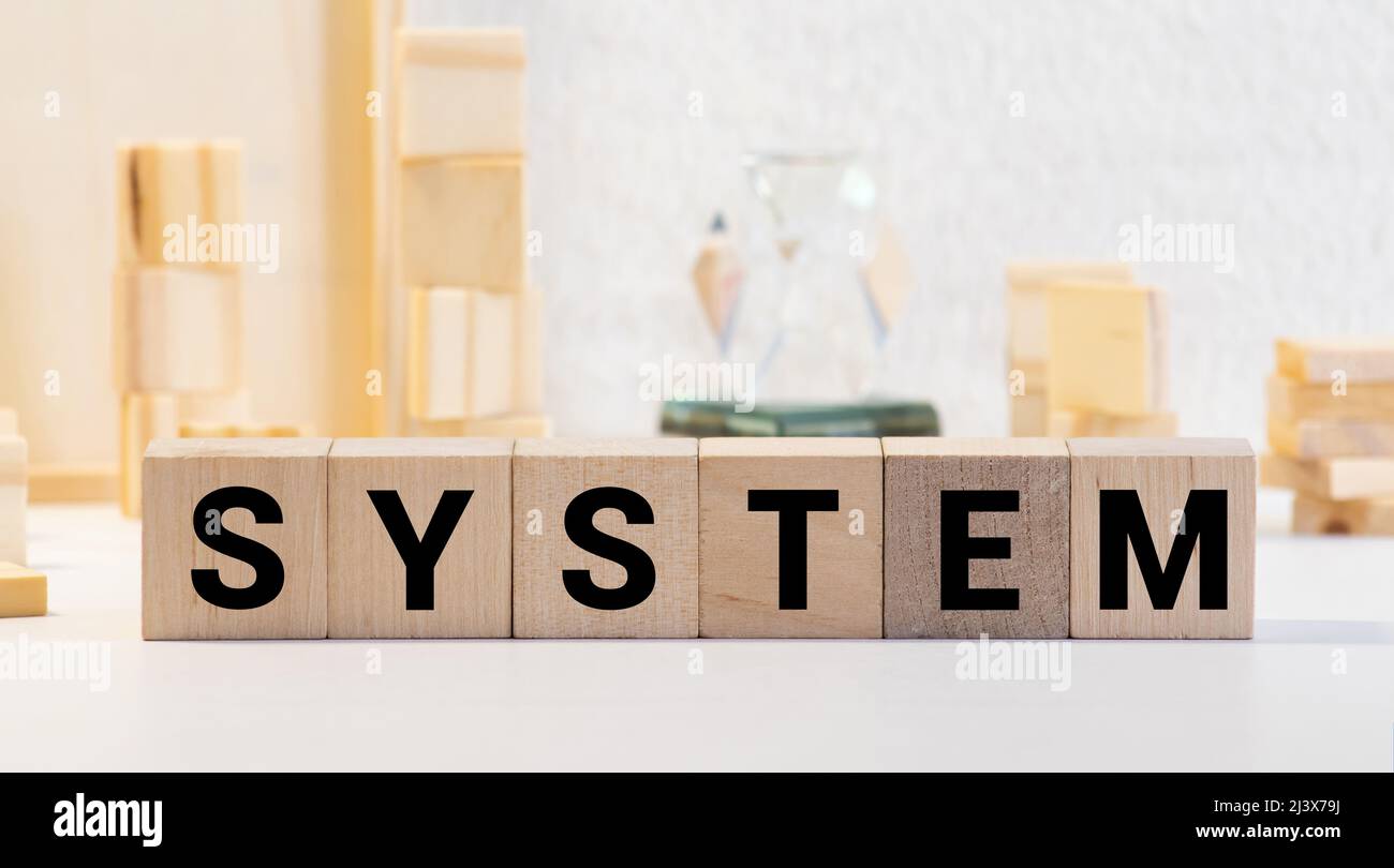 system - word made with building blocks. A row of wooden cubes with a ...