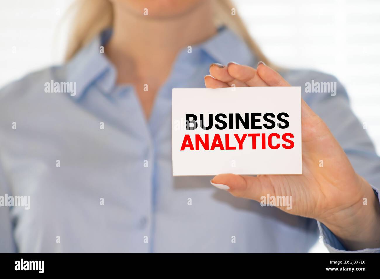 Business Analytics. Man holding a card with a message text written on ...