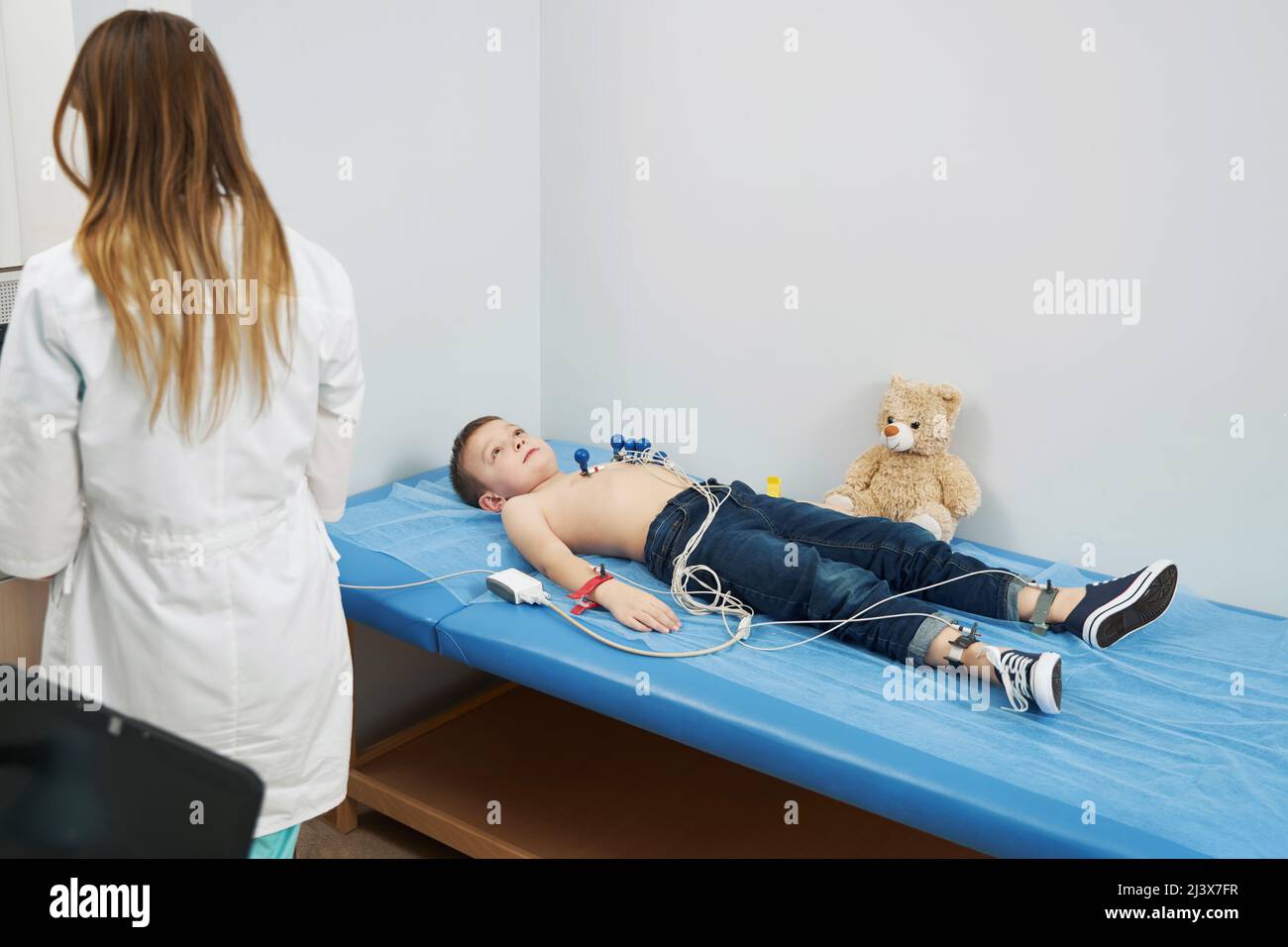 Child undergoing electrocardiogram test in pediatric clinic Stock Photo ...
