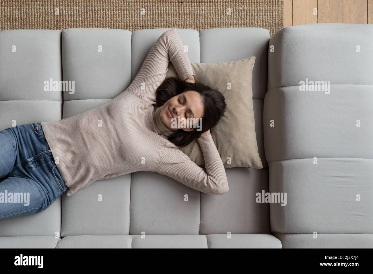 Happy relaxed pretty young woman lying on sofa at home Stock Photo - Alamy
