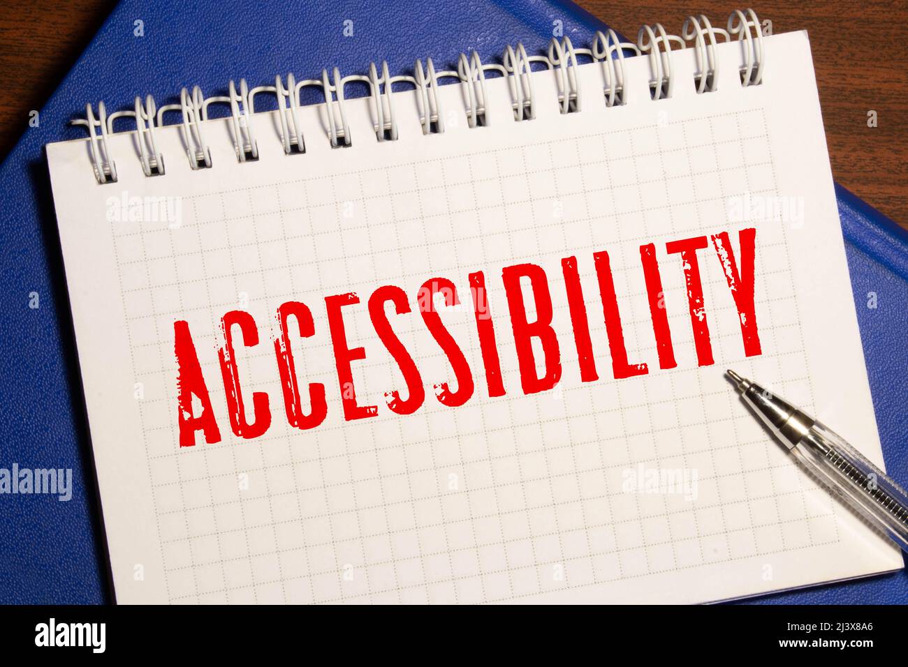 The word Accessibility appearing behind torn brown paper ...