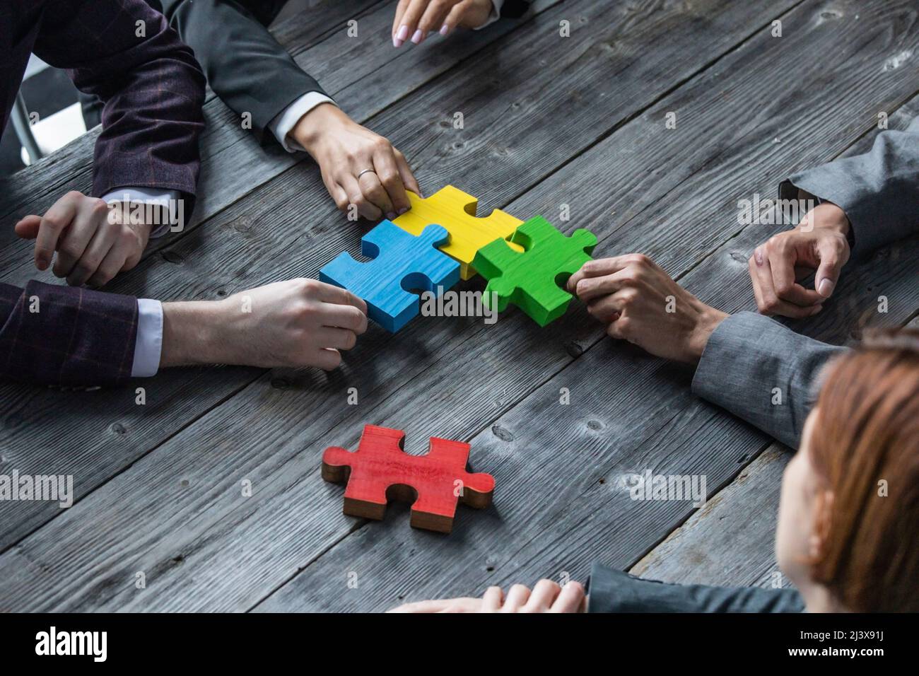 Diverse team people assembling jigsaw puzzle, multiracial group of ...