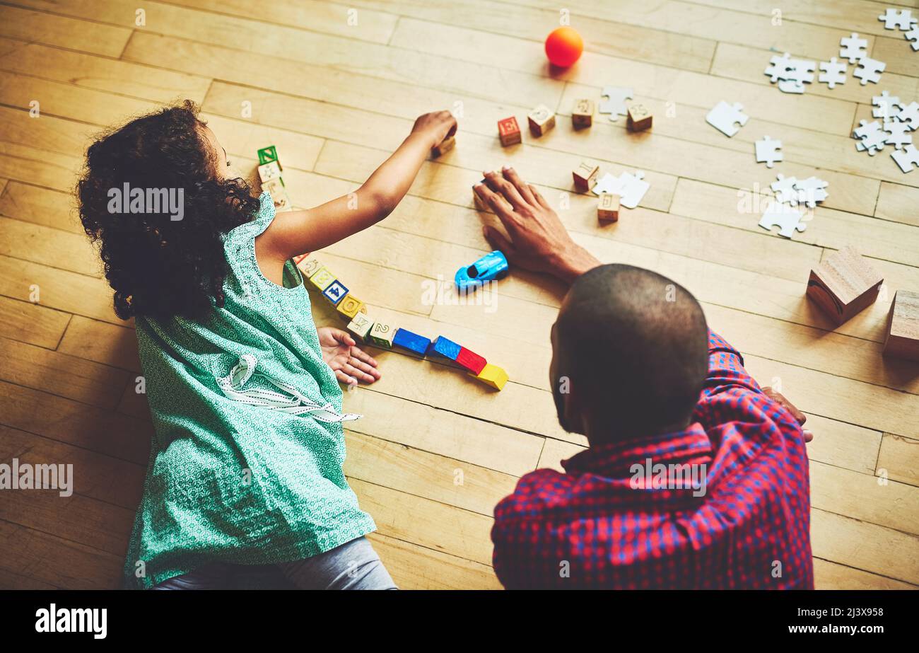 Playtime with dad. Cropped shot of a father spending some quality time with his daughter Stock ...