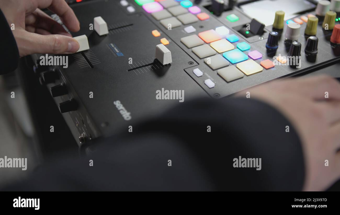 Click colored squares on mixer panel. ART. Hands in dark room are ...