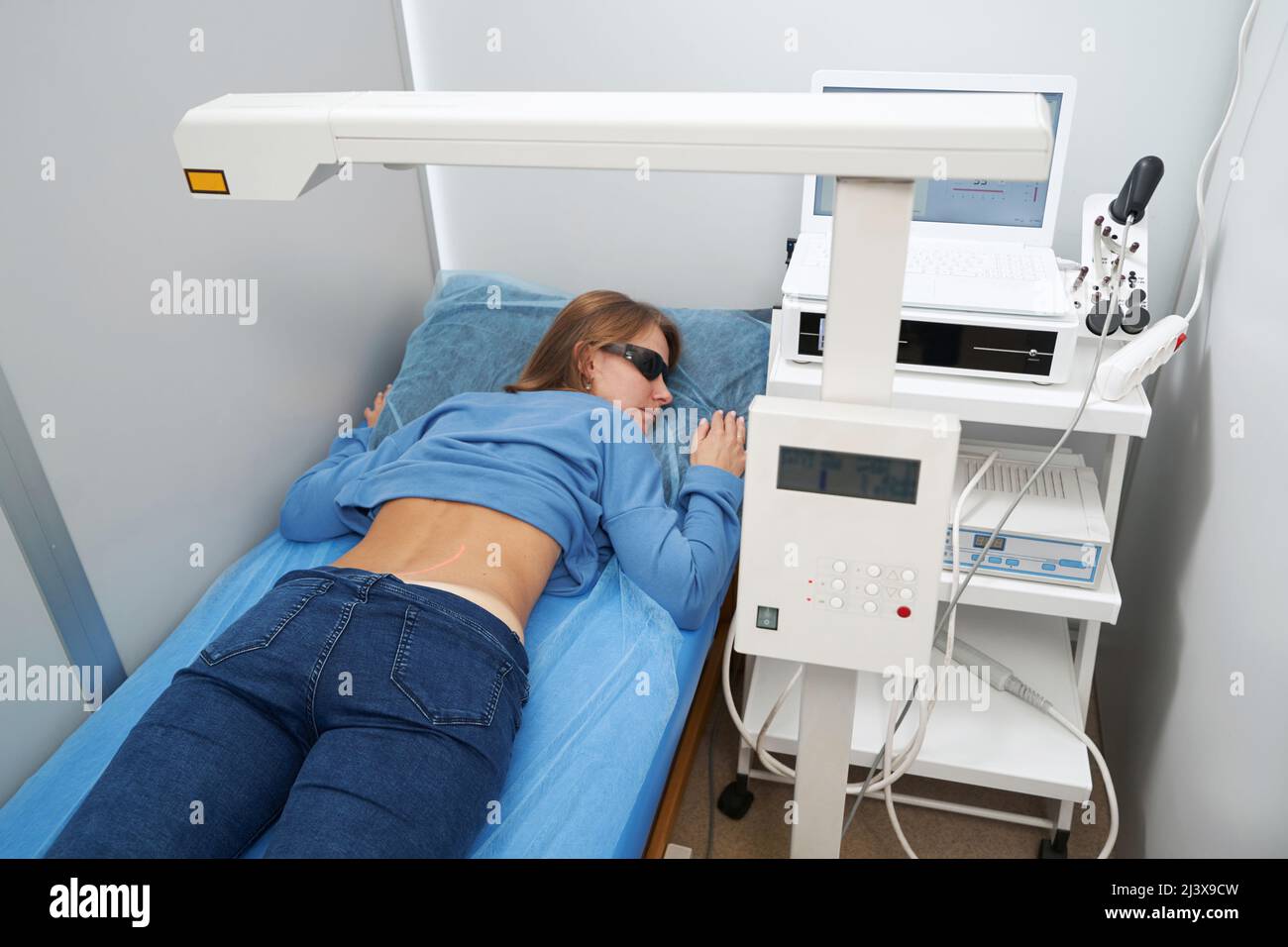 Female patient receiving laser treatment in clinic Stock Photo - Alamy