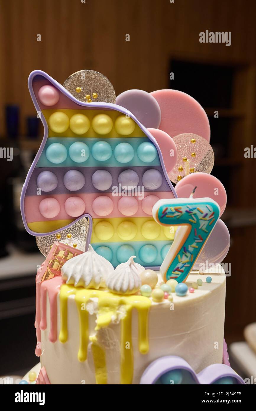 Pastel pink baby Birthday Cake with Sprinkles decor and candles. 7 ...