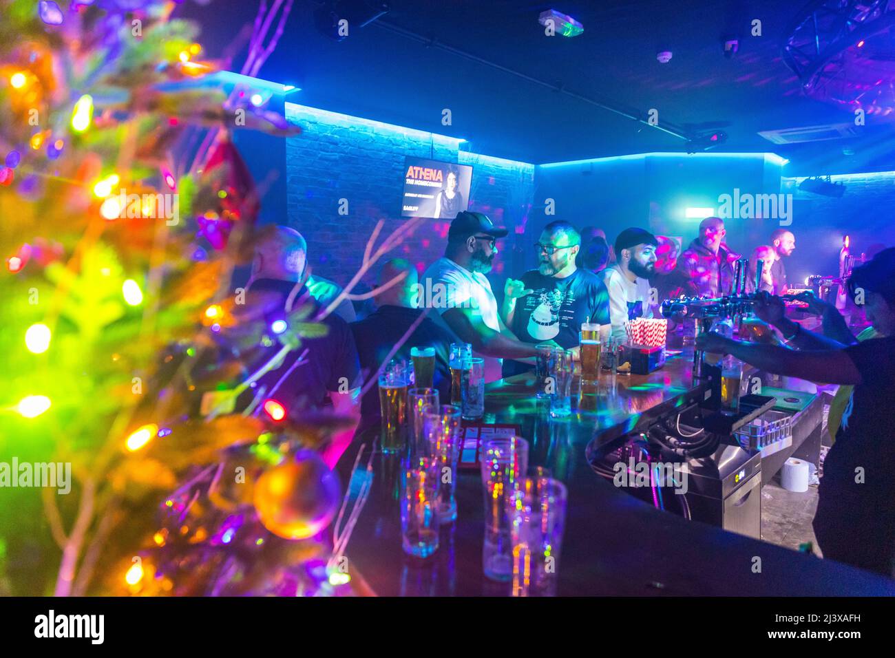 Christmas lights in a bar with customers ordering drinks Stock Photo ...