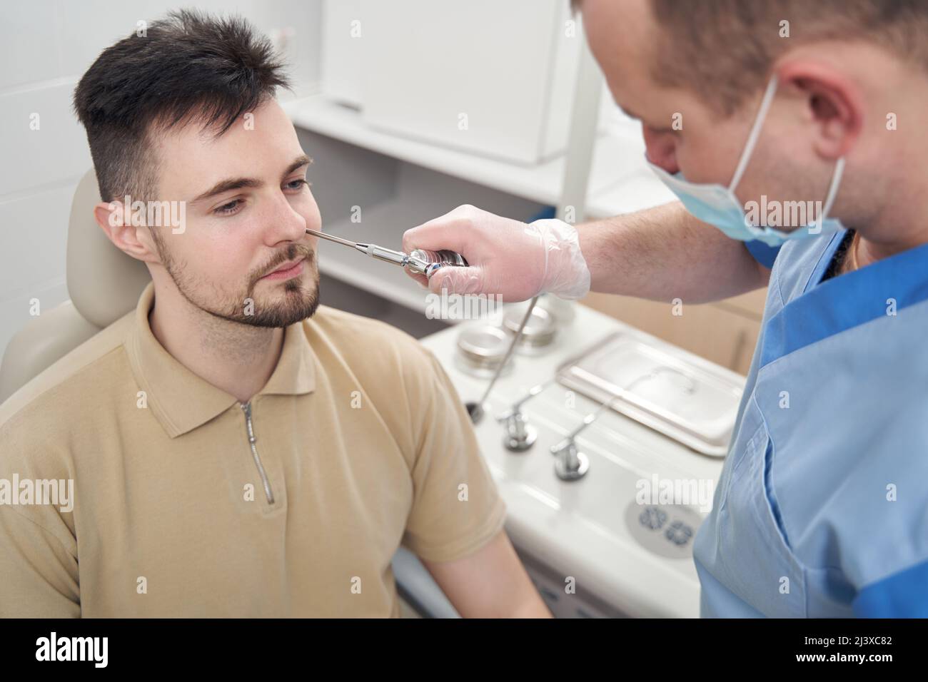 Otorhinolaryngologist using medical tools in patient nosetril Stock ...