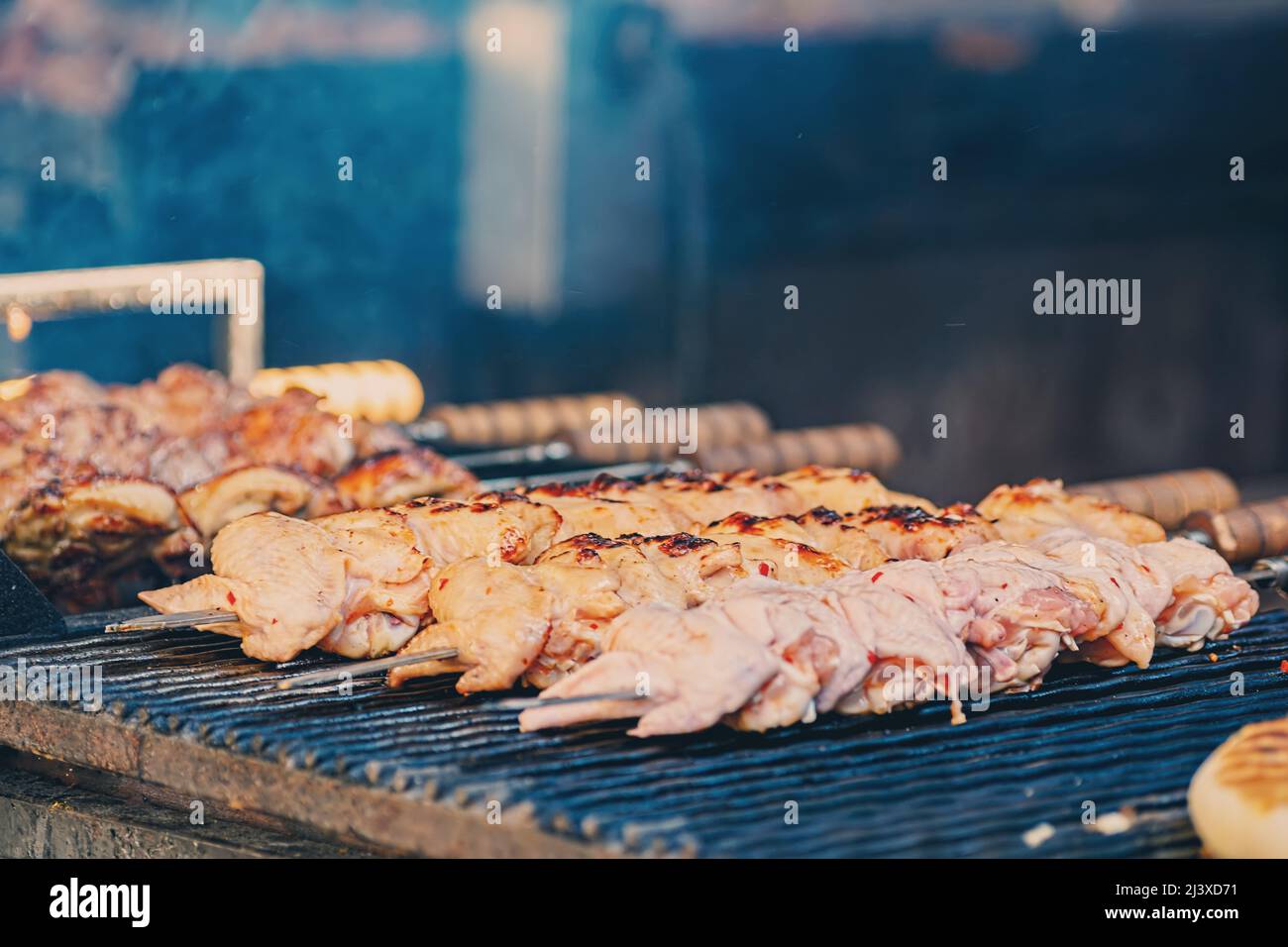 Chicken wings fried on fire With smoke. Toning Stock Photo - Alamy