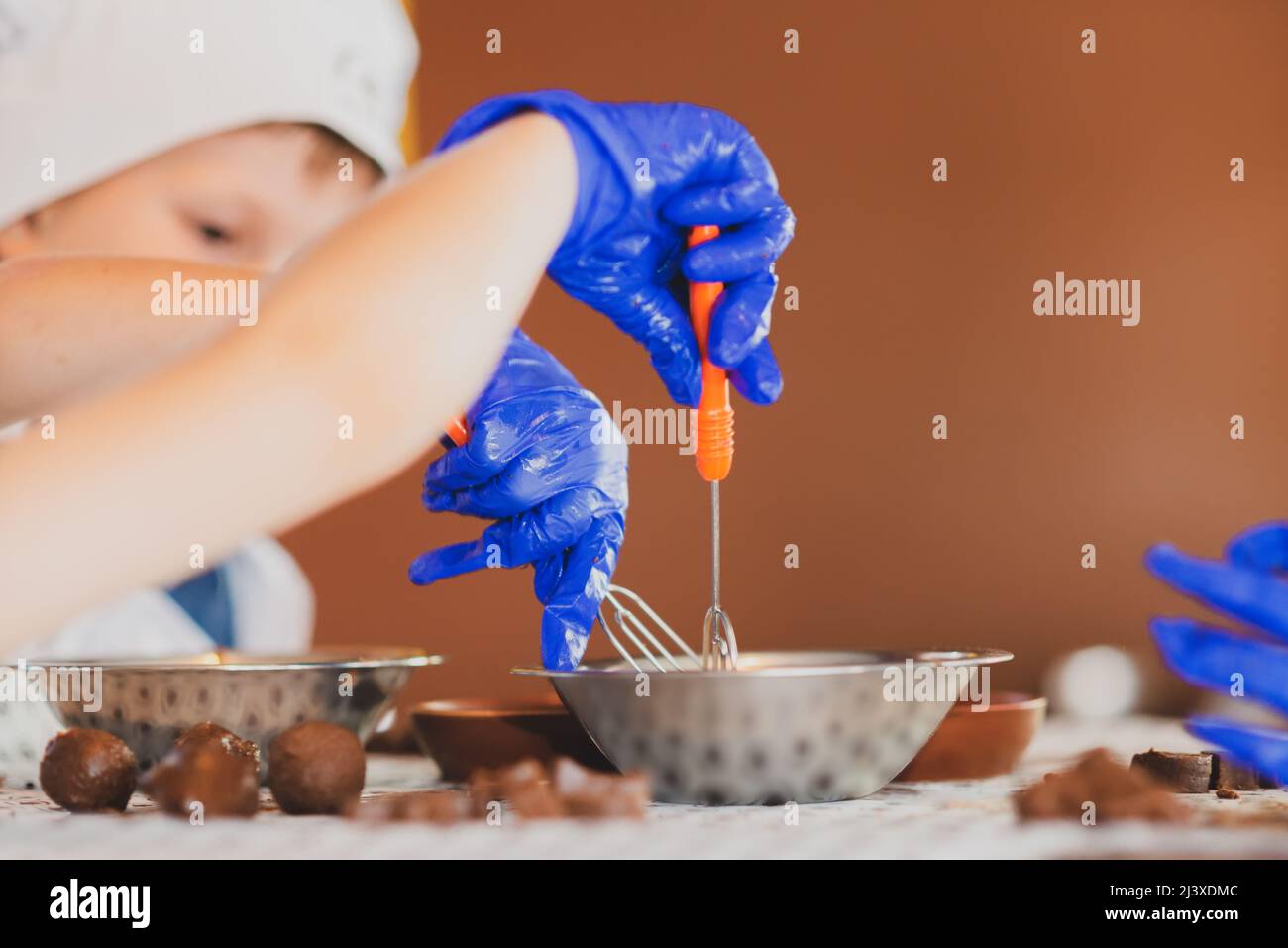 Children make simple figures from chocolate at a master class Stock ...