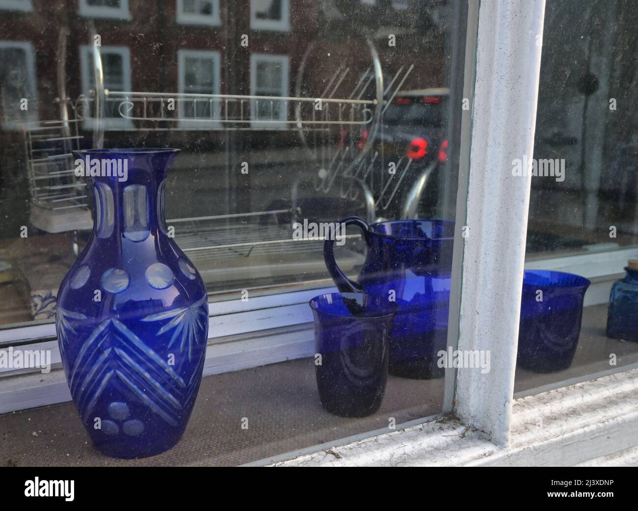display of blue glassware in kitchen window Stock Photo - Alamy