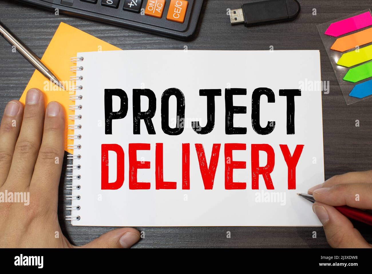 businesman hold notepad with text PROJECT DELIVERY. White background ...