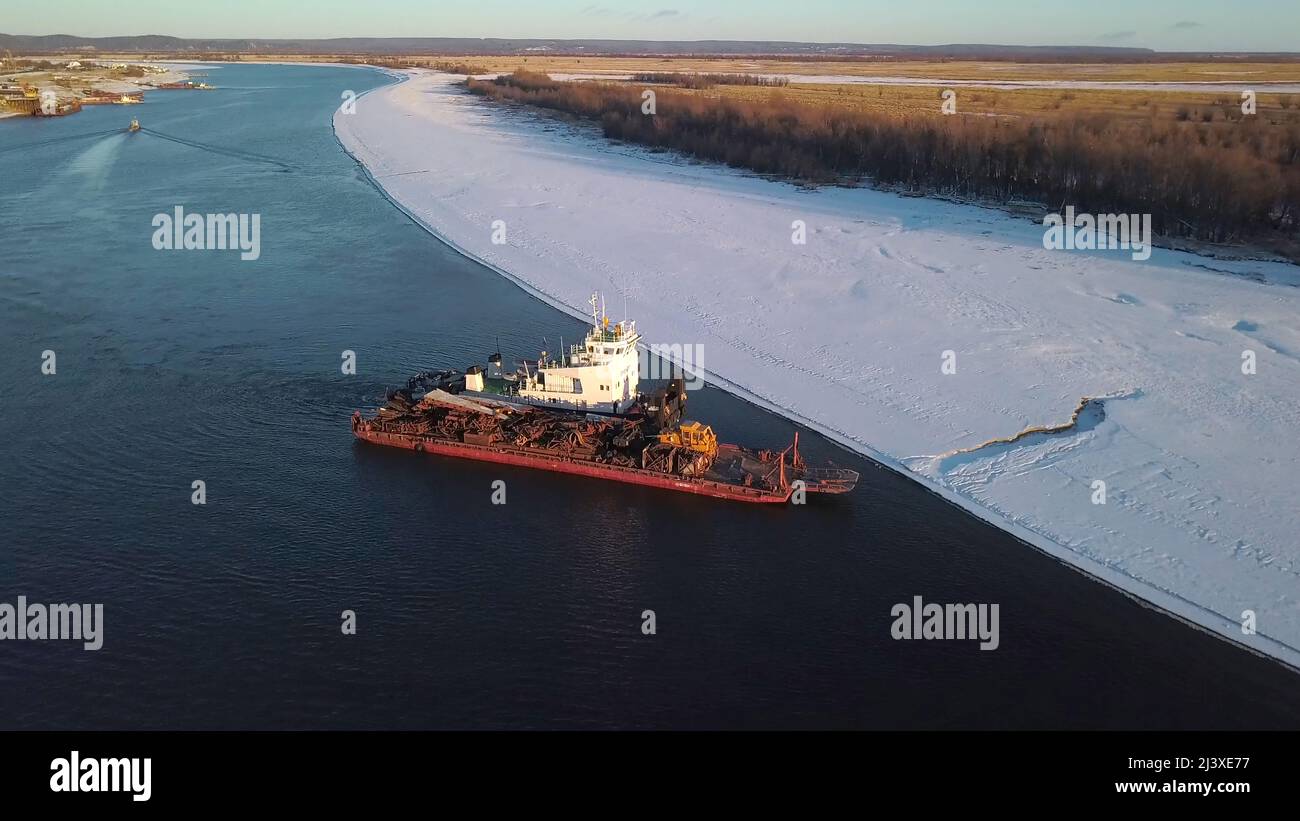 A ship carrying cargo. Clip. Ships sailing in a spring melting river ...