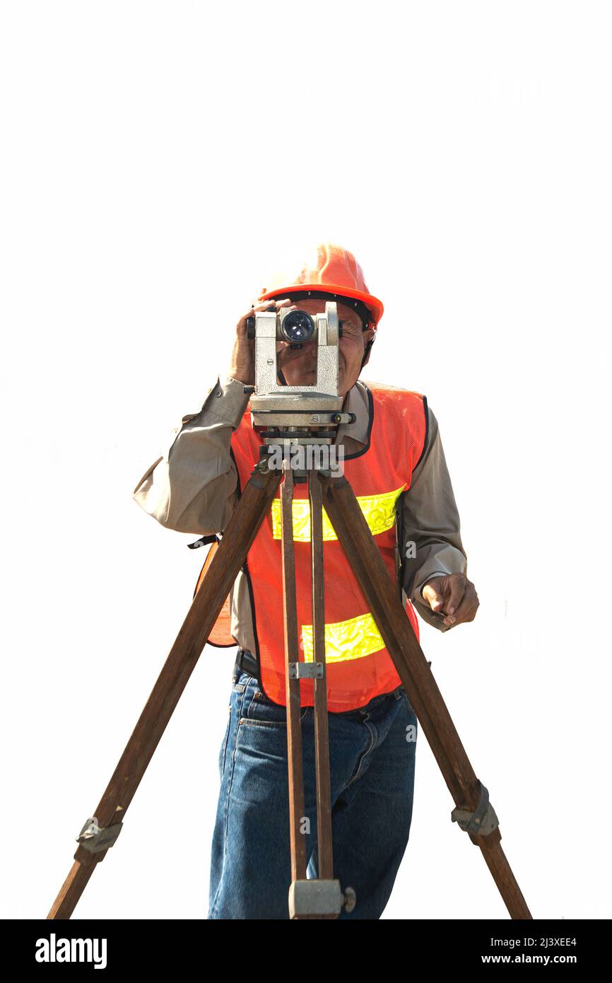 Engineer or surveyor working with theodolite equipment at road ...