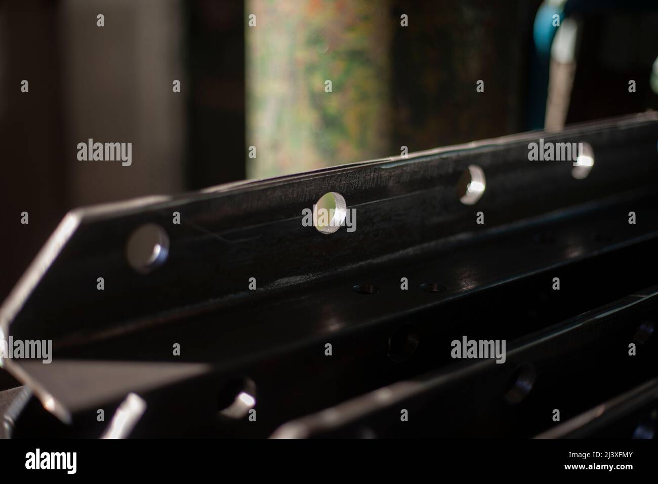 Steel part. Thick metal. Drilled holes in workpiece. Details of metal ...