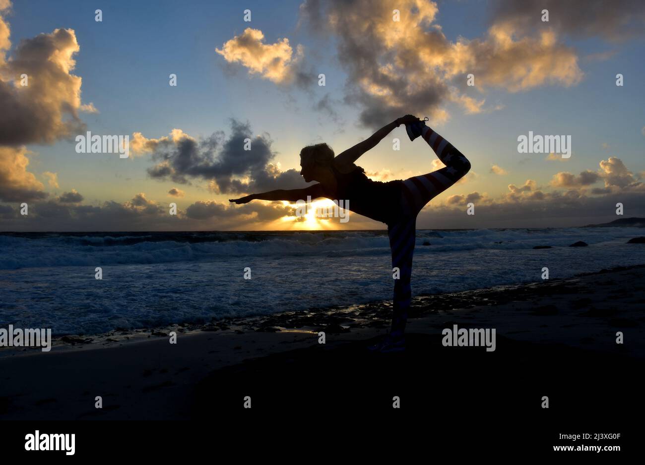 Yoga dancer pose silhouetted on the coast of Aruba Stock Photo - Alamy