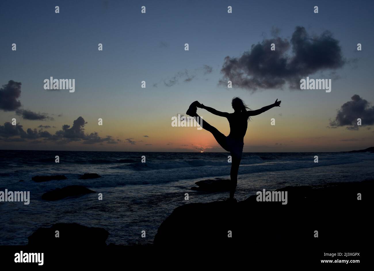 Silhouetted balance toe bind pose at sunrise in Aruba Stock Photo - Alamy