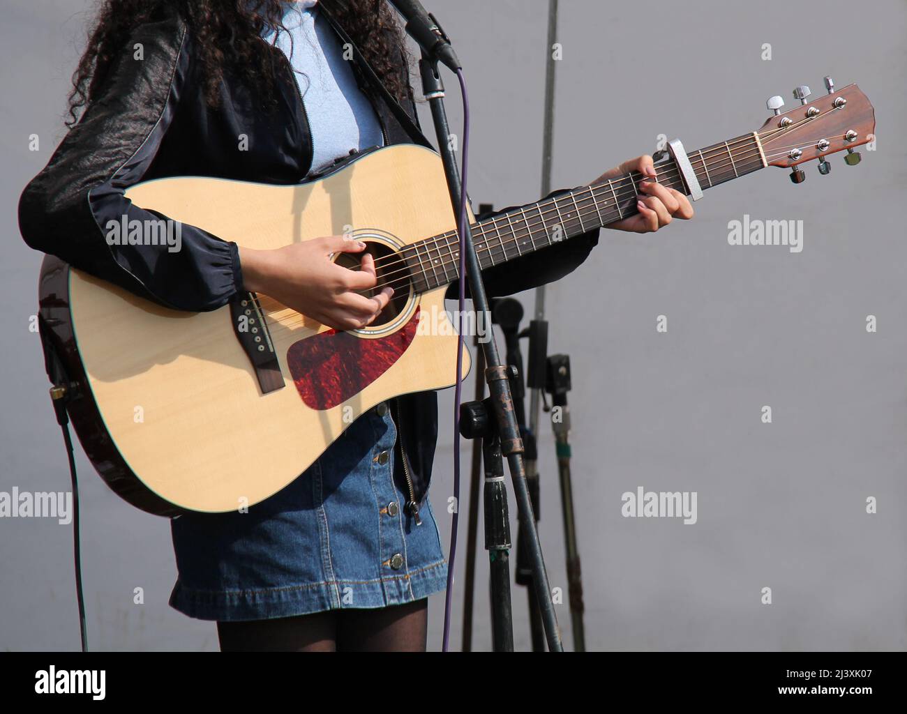 A Young Female Singer Performing with a Guitar Stock Photo - Alamy
