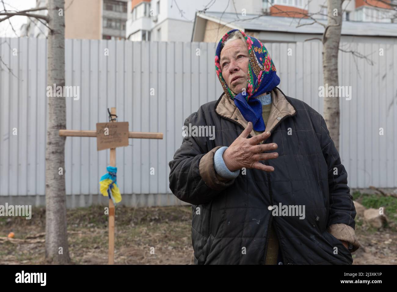 BUCHA, UKRAINE - Apr. 06, 2022: Local woman near the grave of her ...