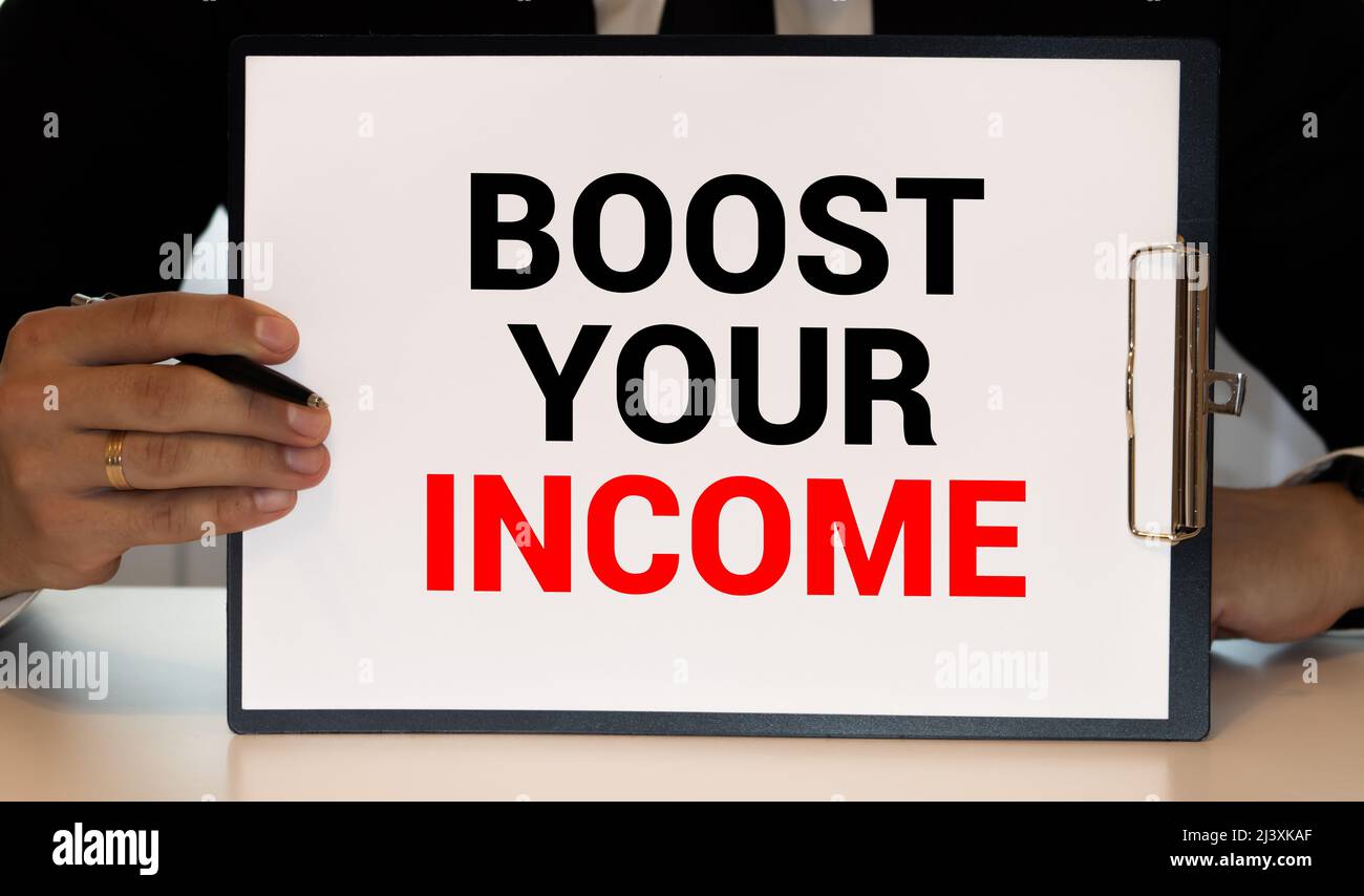 text BOOST YOUR INCOME on white paper, concept Stock Photo - Alamy