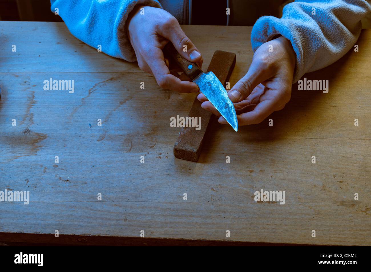 A man checks the sharpness of a knife.Touch the blade of a knife. Run ...