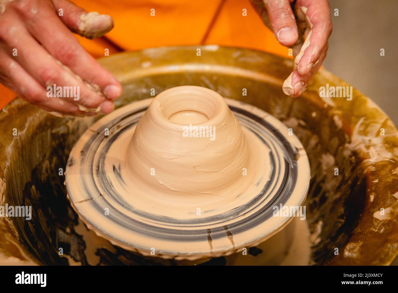 Potter working on potters wheel with clay. Process of making ceramic ...