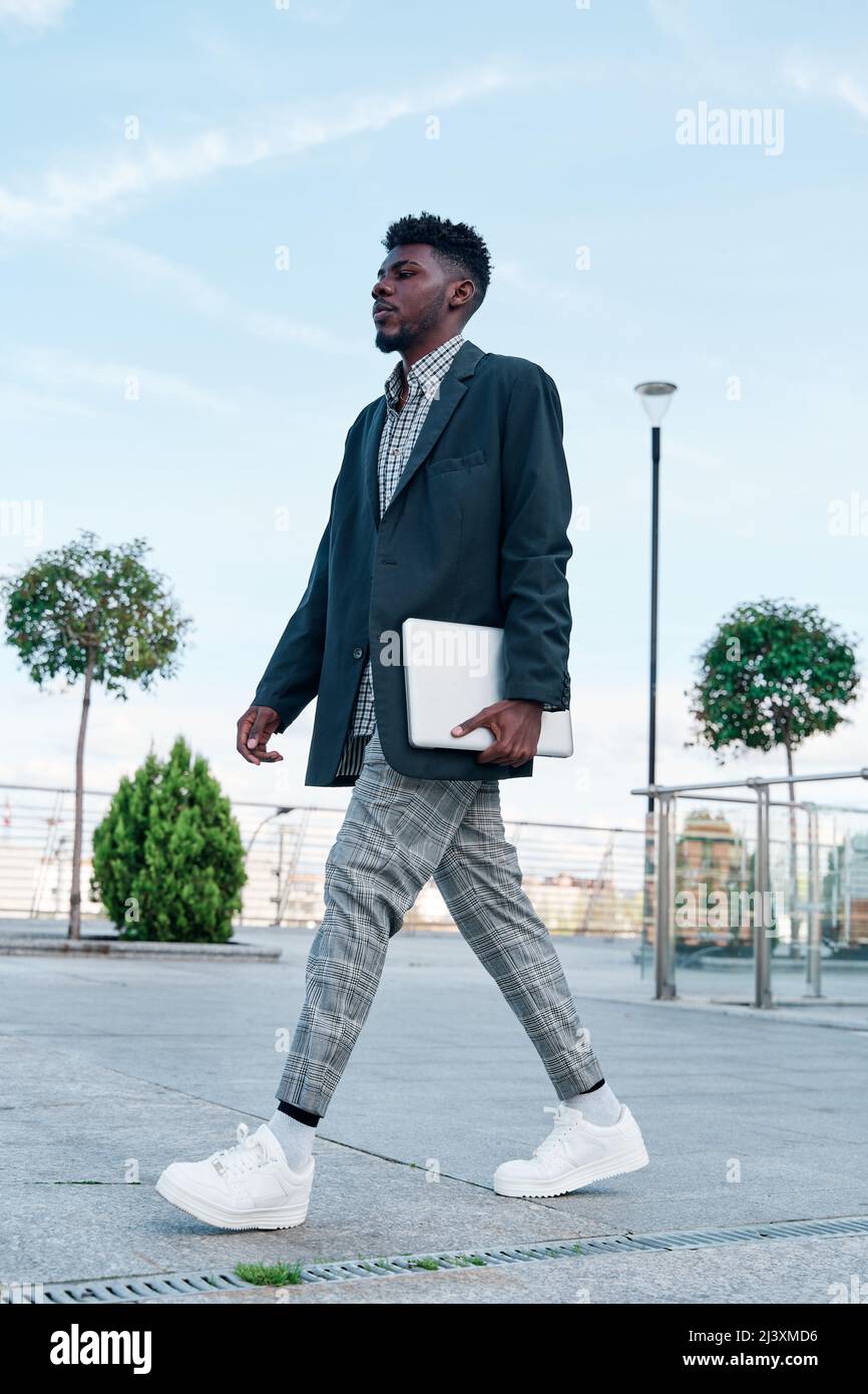 Professional man walking laptop computer hi-res stock photography and ...