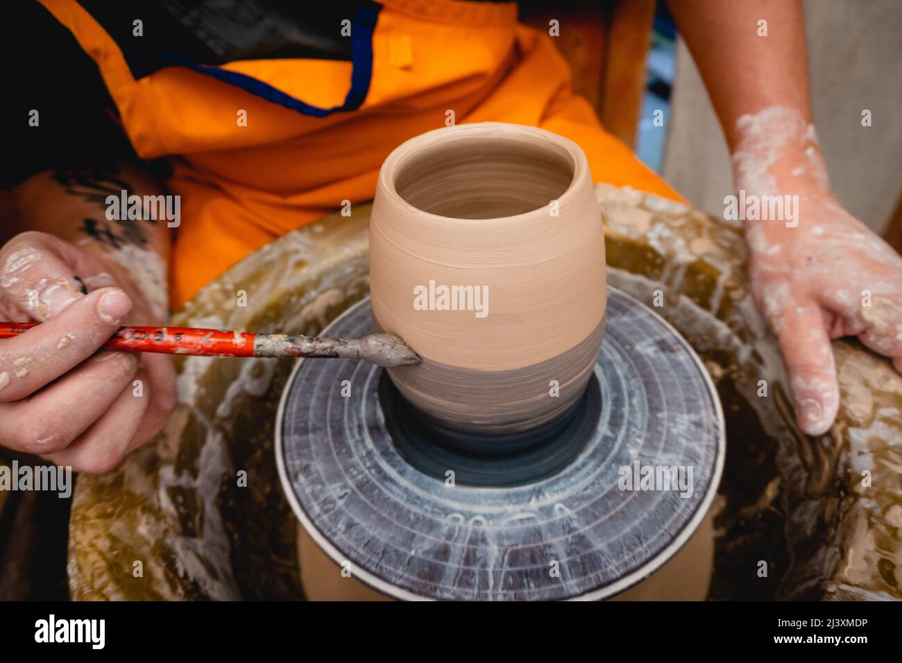 Potter working on potters wheel with clay. Process of making ceramic ...