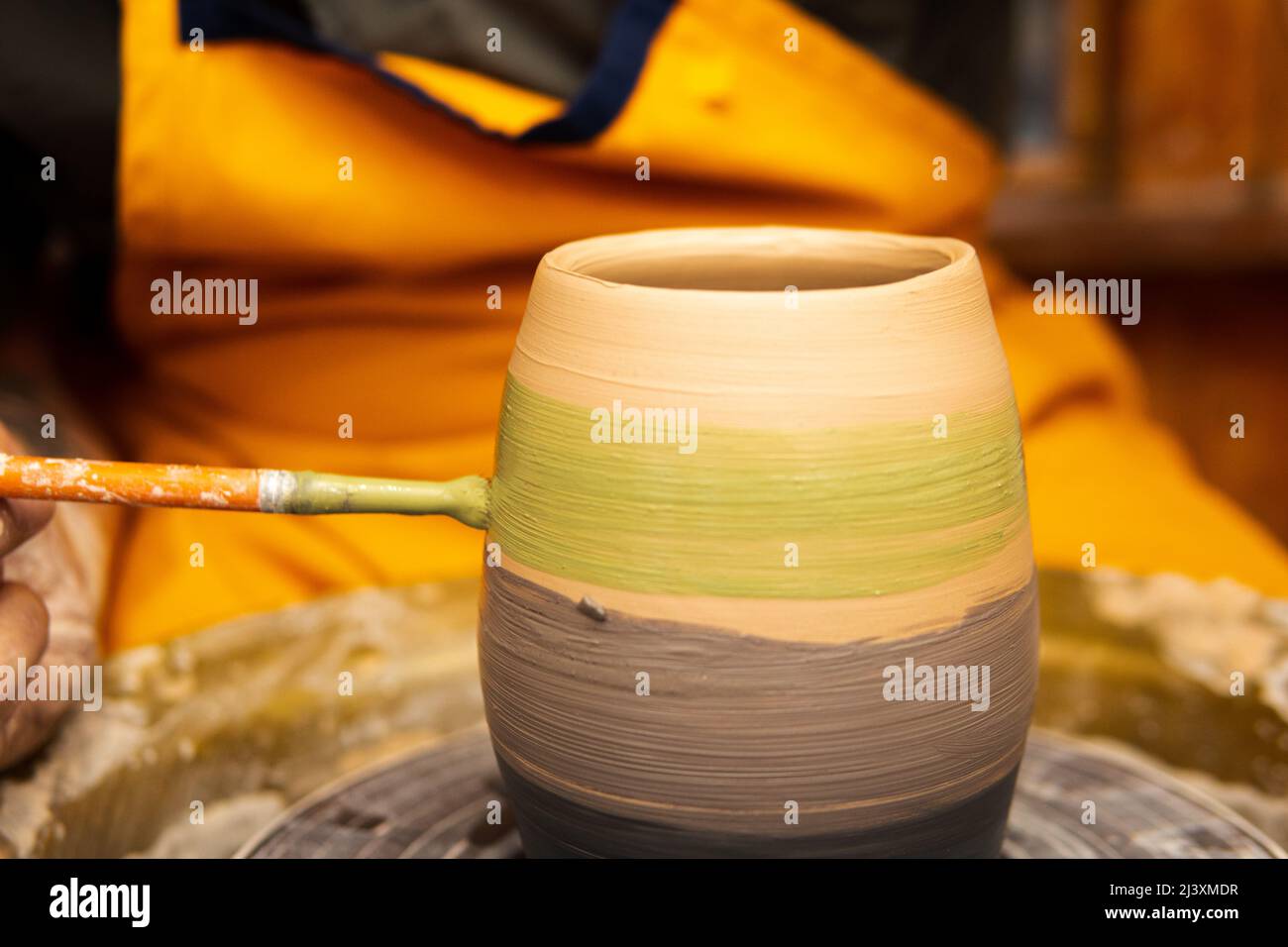 Potter working on potters wheel with clay. Process of making ceramic ...
