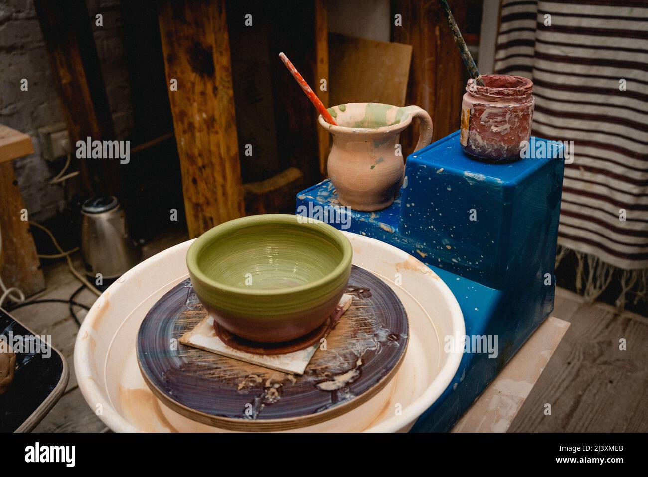 Potter working on potters wheel with clay. Process of making ceramic ...