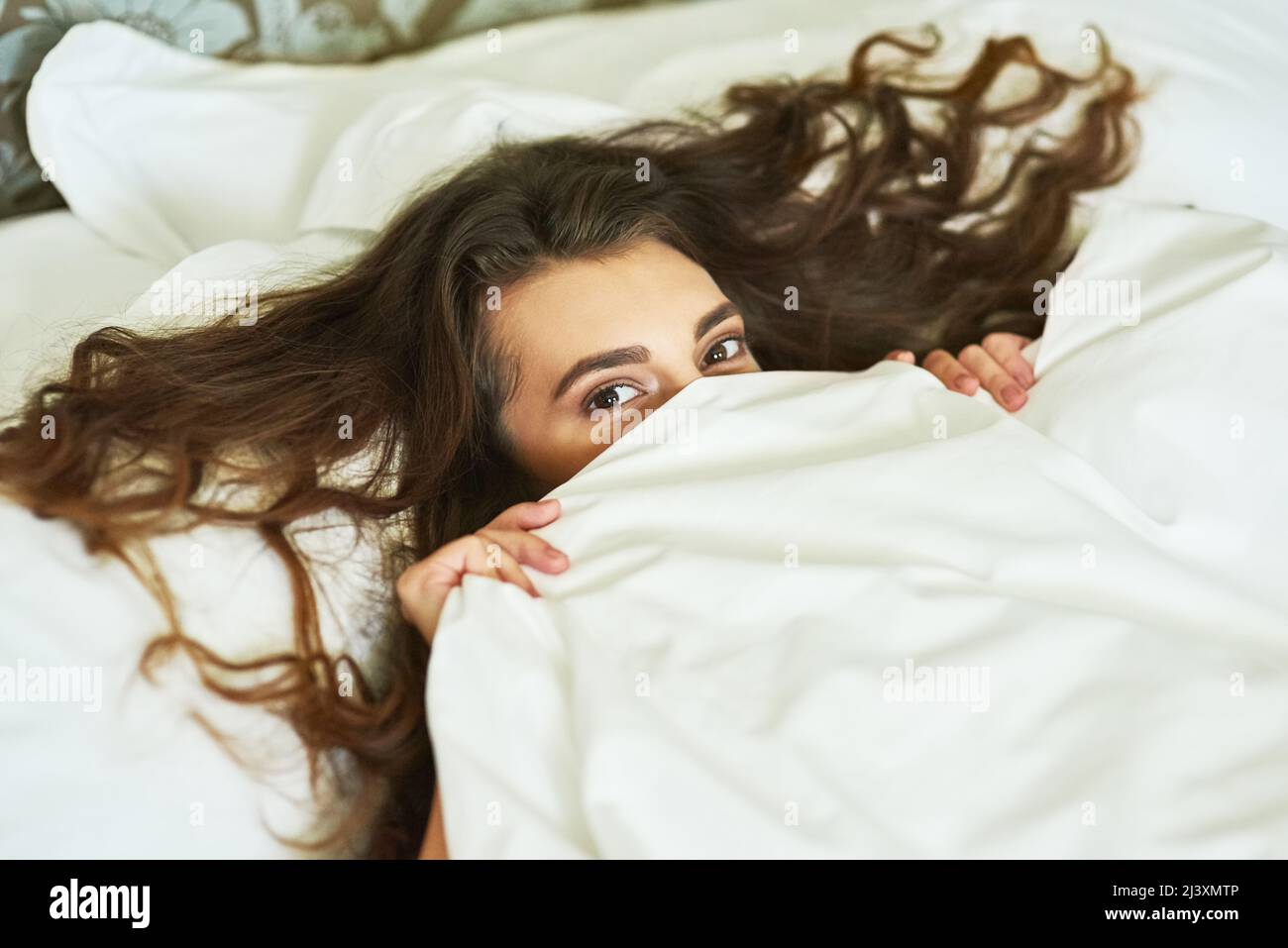 Under the covers is where Im staying. High angle portrait of an ...