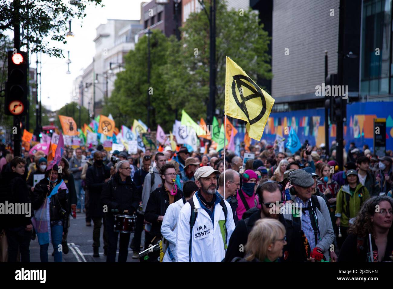 Protestors march with flags and placards expressing their opinion ...