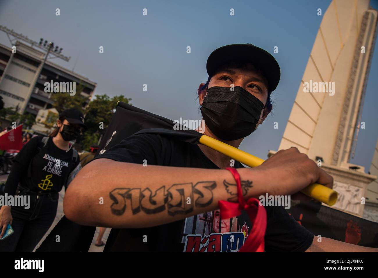 A protester poses for photo with tattoo on his arm saying "People ...